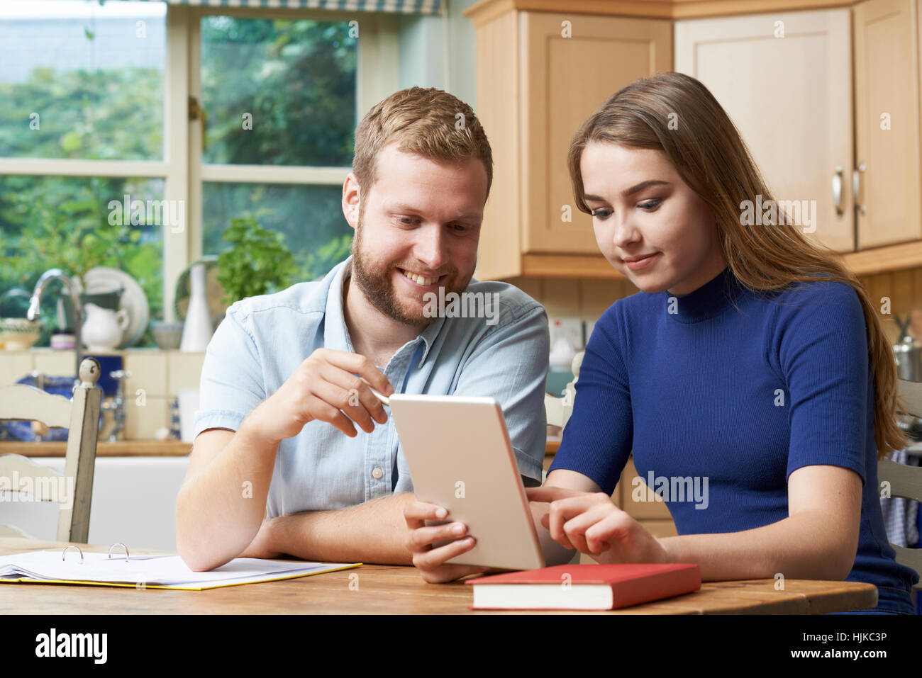 Male Home Tutor Helping Teenage Girl With Studies Stock Photo - Alamy