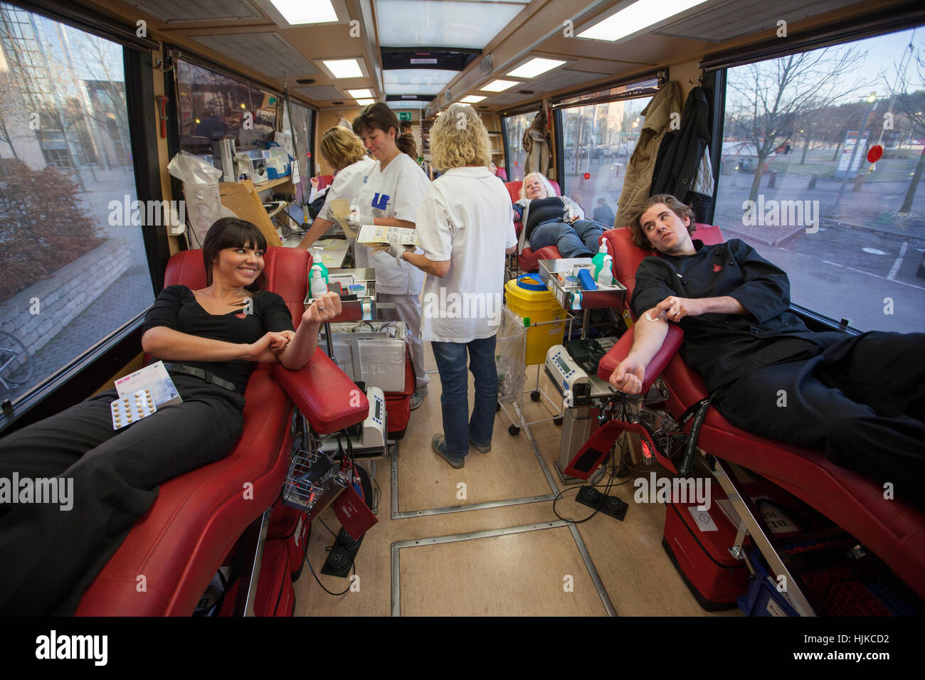 Blood donors visiting the blood bus to donate blood Stock Photo - Alamy
