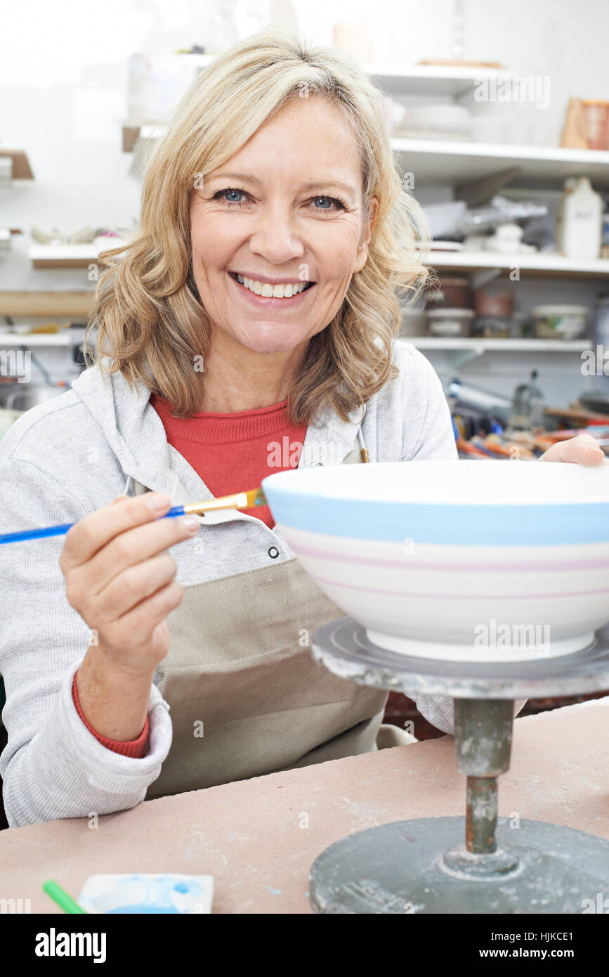 Mature Woman Decorating Bowl In Pottery Class Stock Photo - Alamy