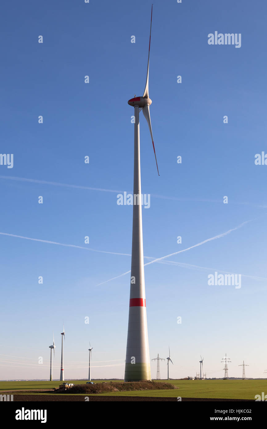 Giant Wind Turbine Under Blue Sky Stock Photo - Alamy