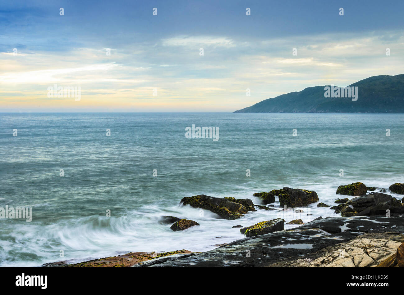 Sun rise with water sea waves splashing on sea rocks. Horizon and a ...