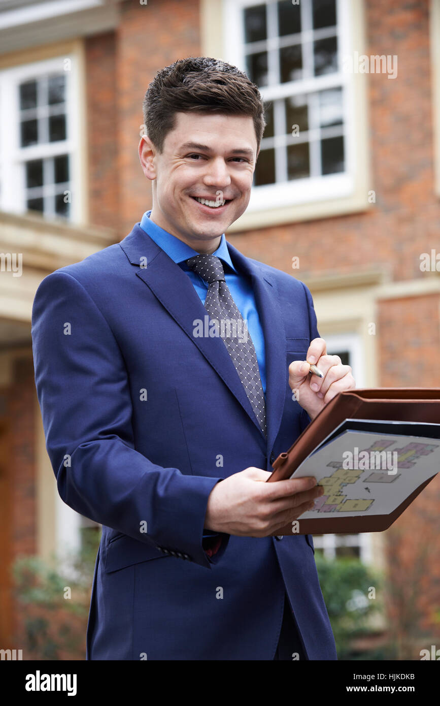 Male Realtor Standing Outside Residential Property Stock Photo - Alamy