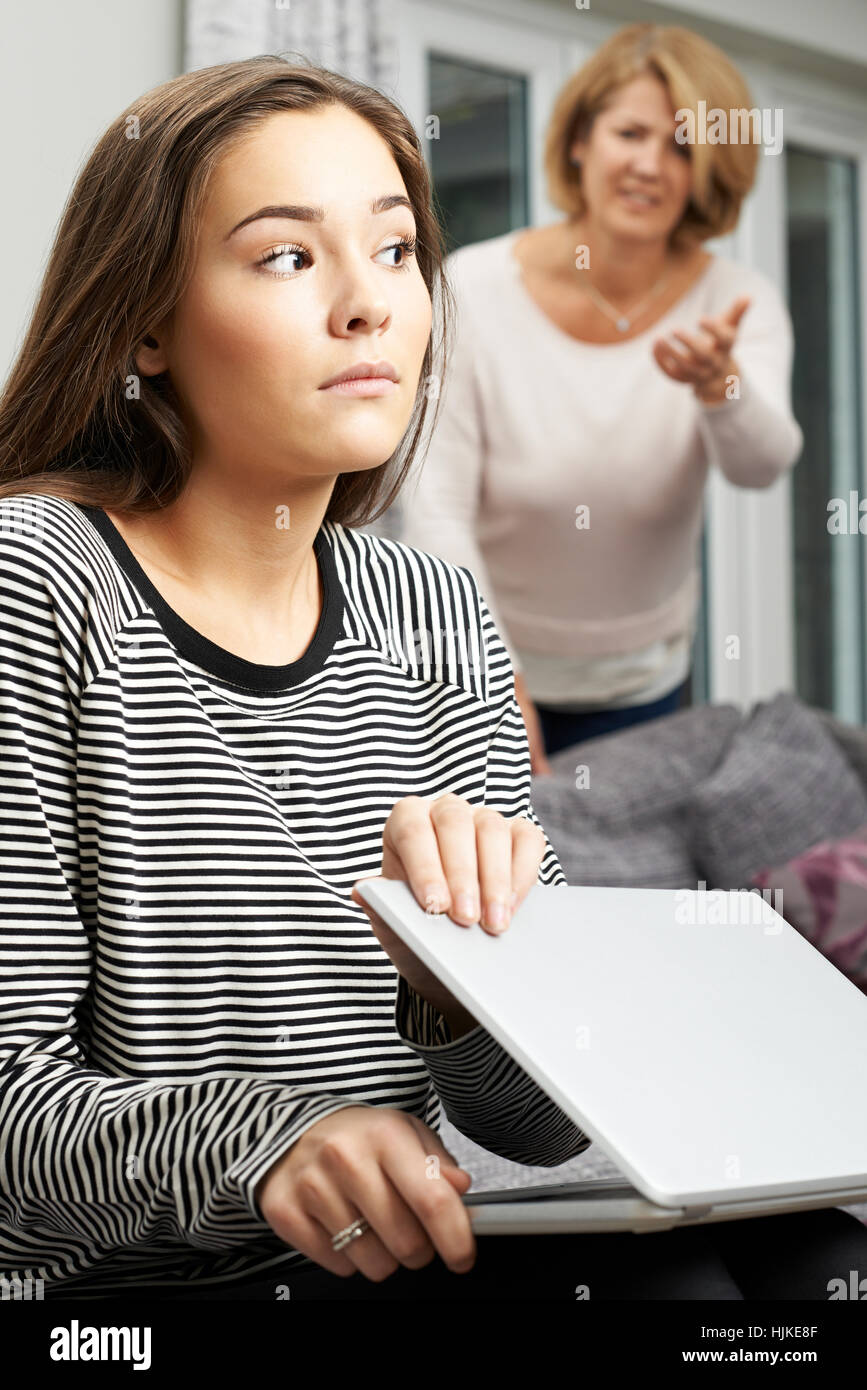 Teenage Girl Hiding Internet Use From Mother Stock Photo - Alamy