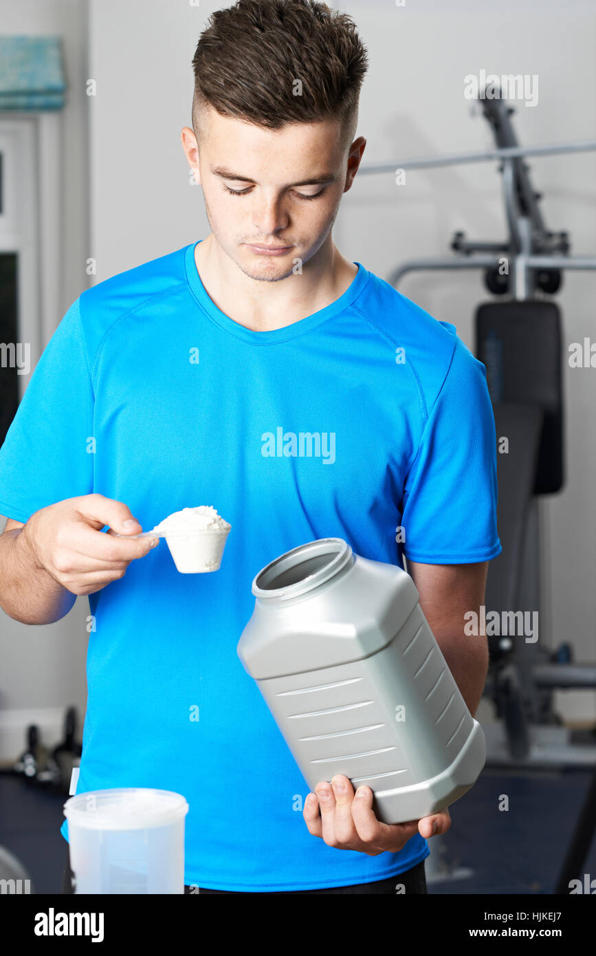Young Man In Gym Taking Nutritional Supplement Stock Photo - Alamy