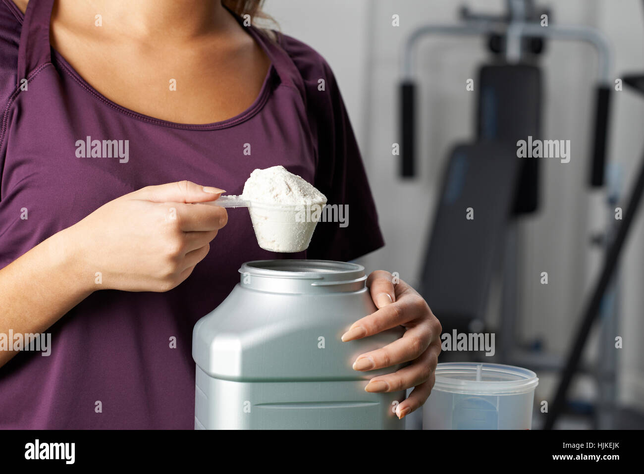 Young Woman In Gym Taking Nutritional Supplement Stock Photo - Alamy