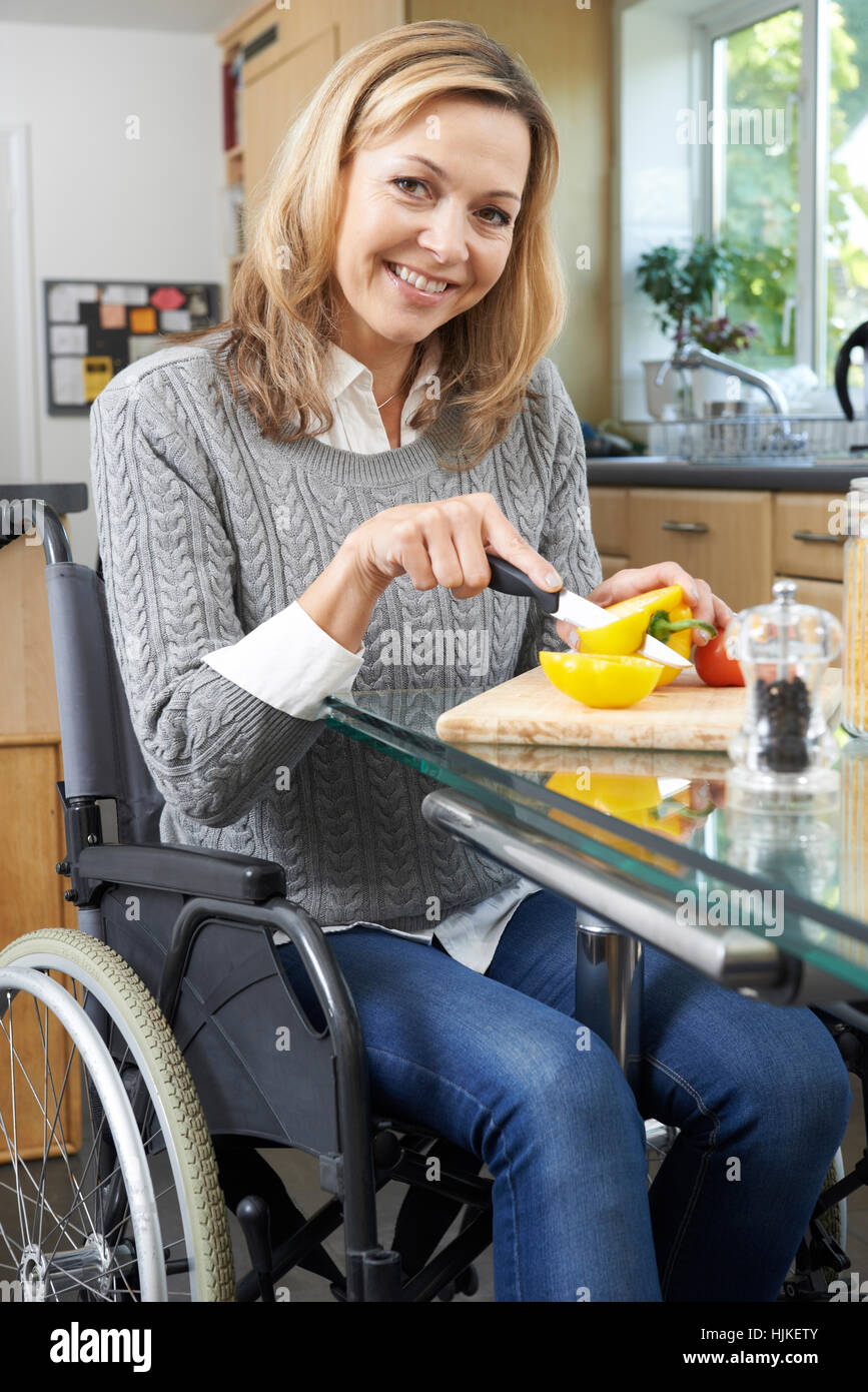 Woman In Wheelchair Chopping Vegetables In Kitchen Stock Photo - Alamy