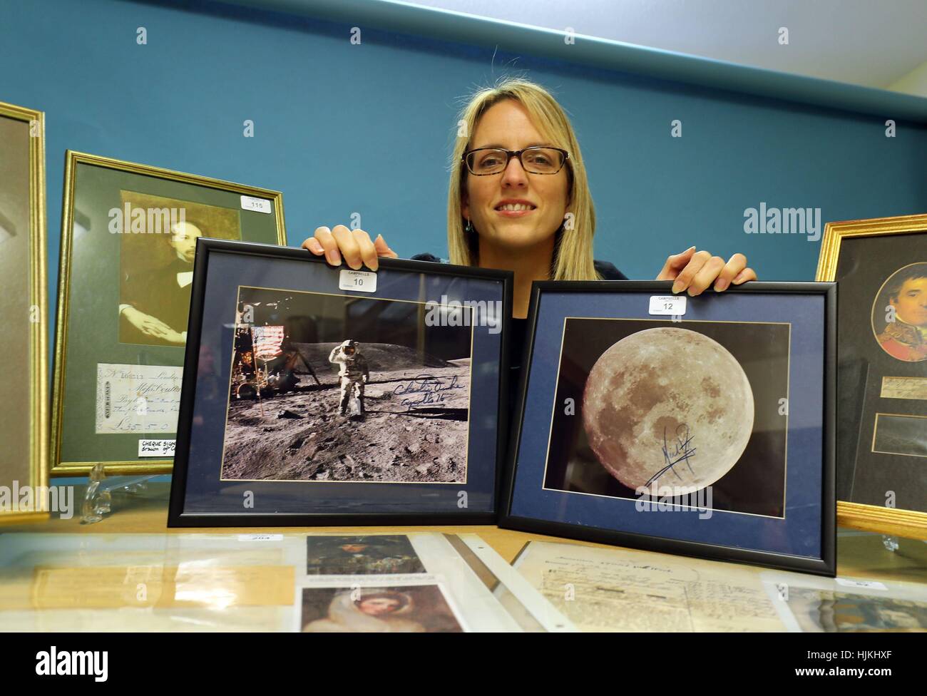 Laura Sykes holds pictures with the signatures of Buzz Aldrin (left ...