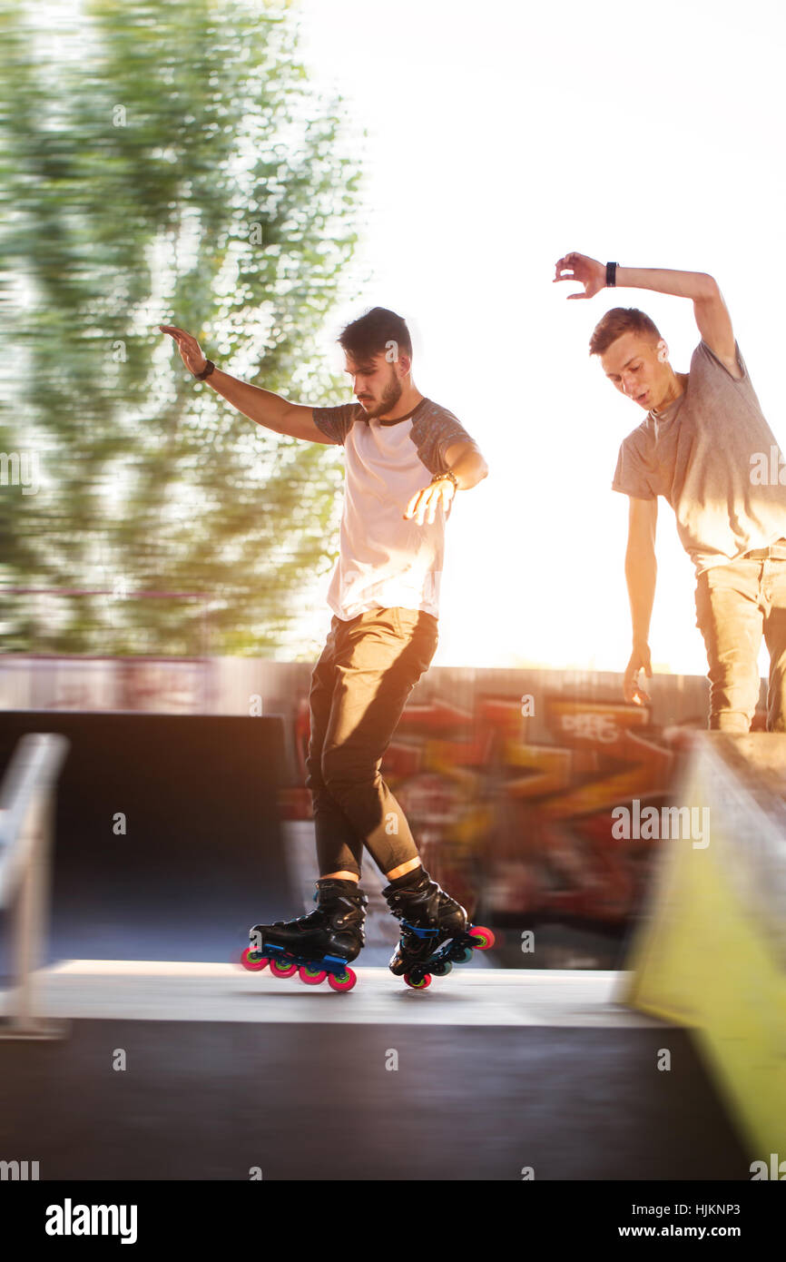 Young people rollerblading Stock Photo - Alamy