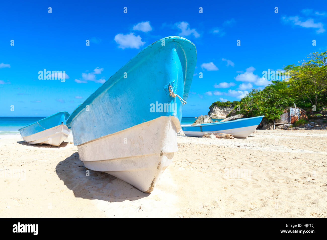Pleasure boat lays on white sand of Macao Beach, coastal landscape ...