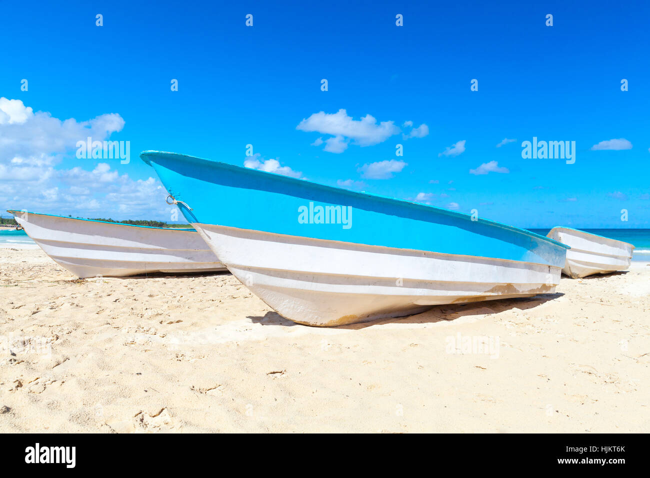 Blue white pleasure boats lay on sand of Macao Beach, coastal landscape ...