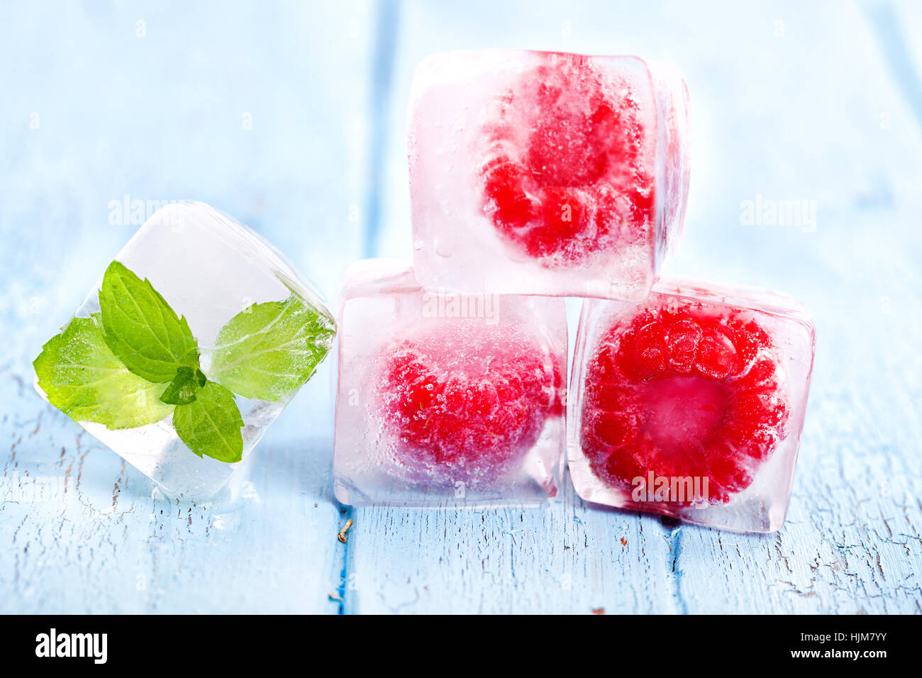 refreshing raspberries in block of ice Stock Photo - Alamy