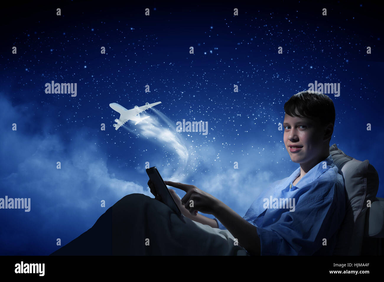 Young teenager guy in bed using tablet pc hi-res stock photography and ...