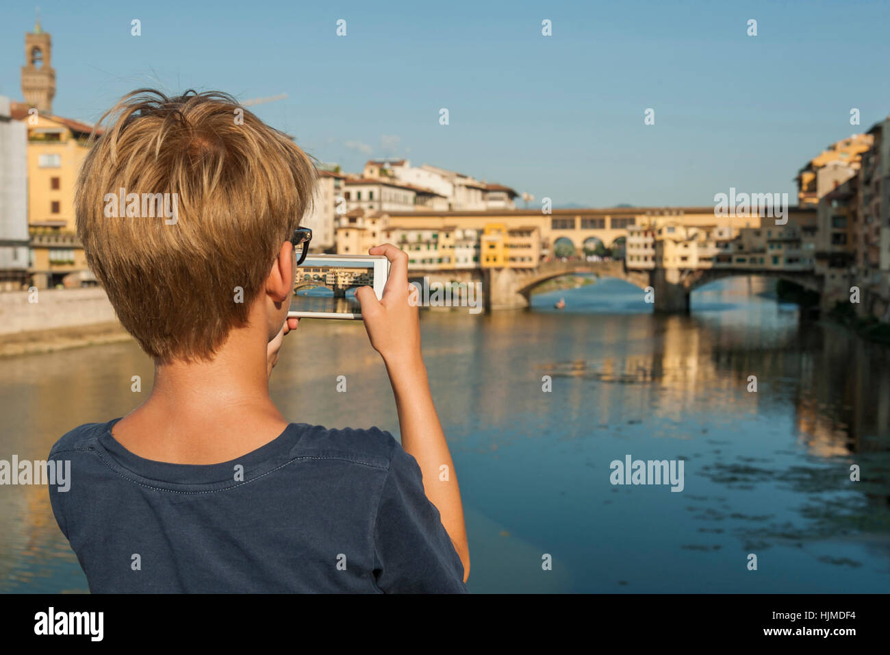 Italy, Tuscany, Florence, Boy taking pictures Ponte Vecchio Stock Photo ...
