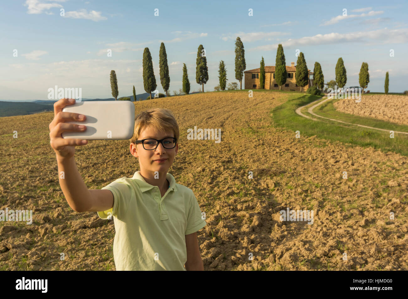 Italy, Tuscany, Boy taking pictures of landscape Stock Photo - Alamy