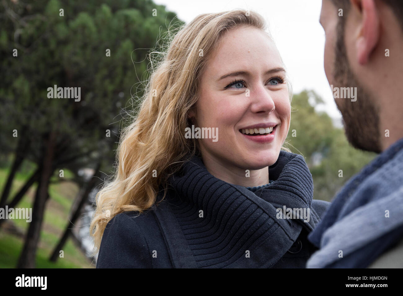 Woman smiling looking at a man outdoors Stock Photo - Alamy