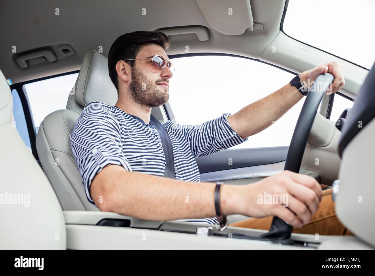 Mid adult man driving in car Stock Photo - Alamy