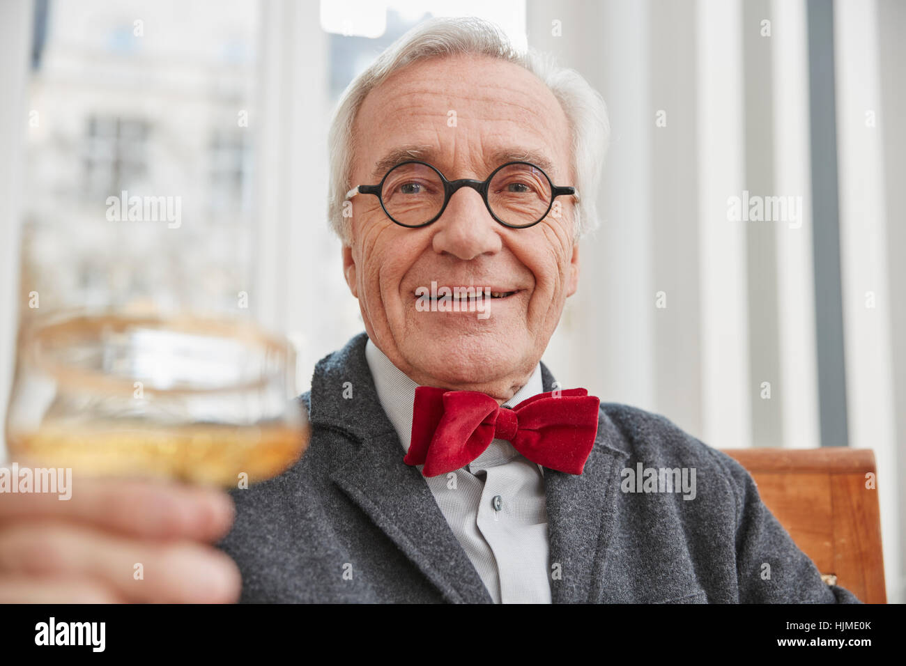 Senior man raising wine glass hi-res stock photography and images - Alamy
