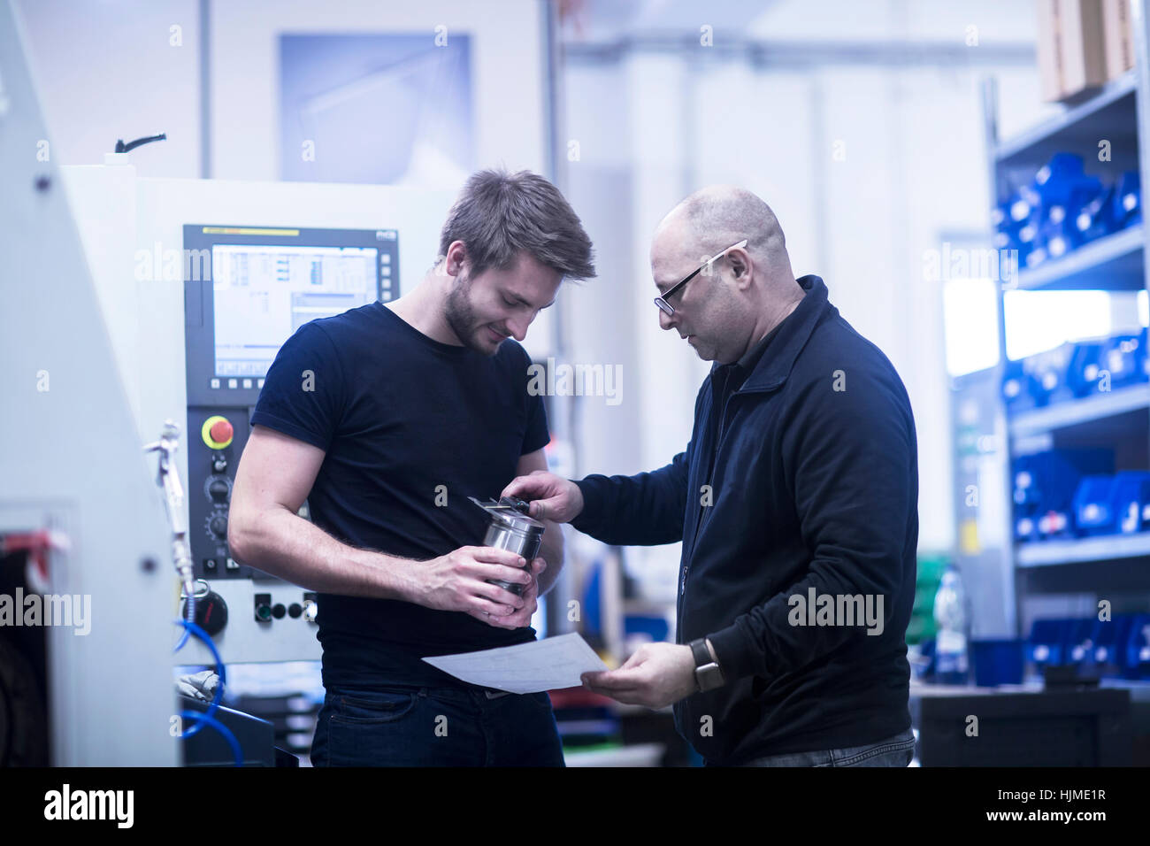 Two men at work in a factory Stock Photo - Alamy