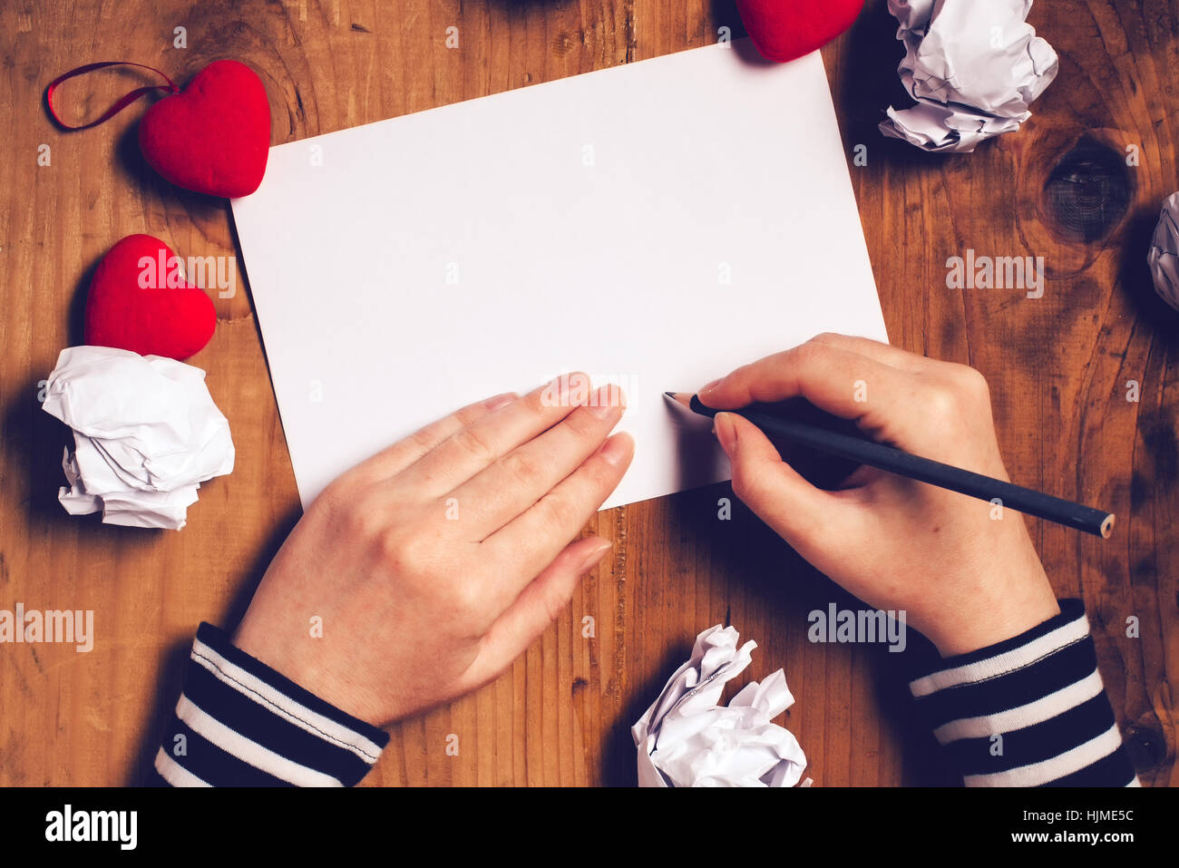 Woman writing love letter or romantic poem for Valentines day, top view ...