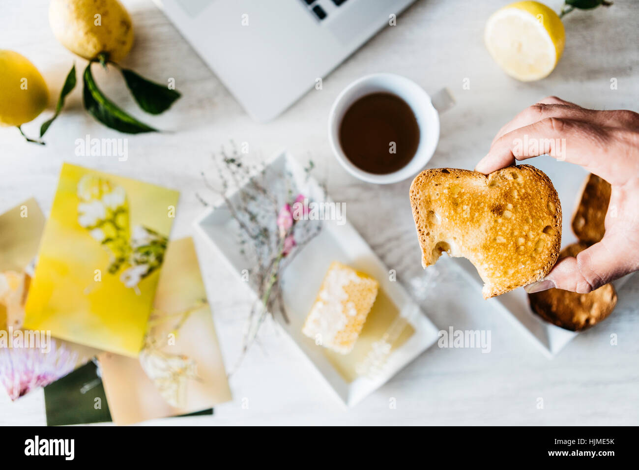 Man's hand holding bitten toast, close-up Stock Photo - Alamy