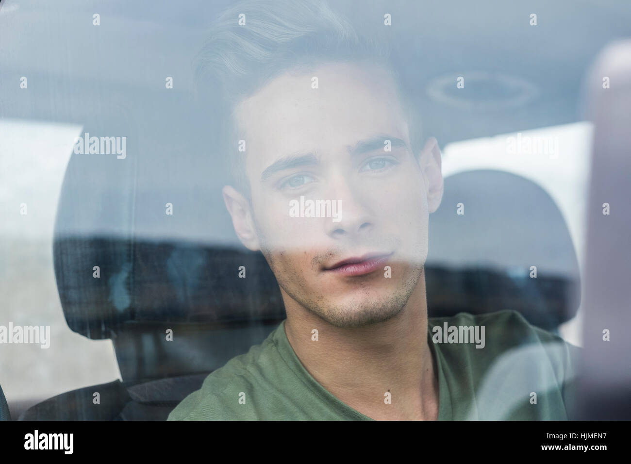 Portrait of young man in a car Stock Photo - Alamy