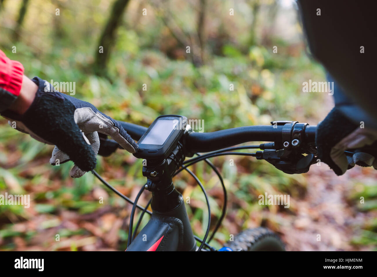 Mountain biker using GPS of his bike, close up Stock Photo - Alamy