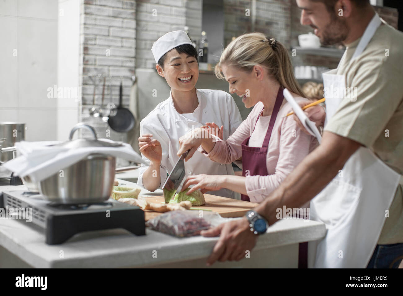 Group of people taking cooking course Stock Photo - Alamy