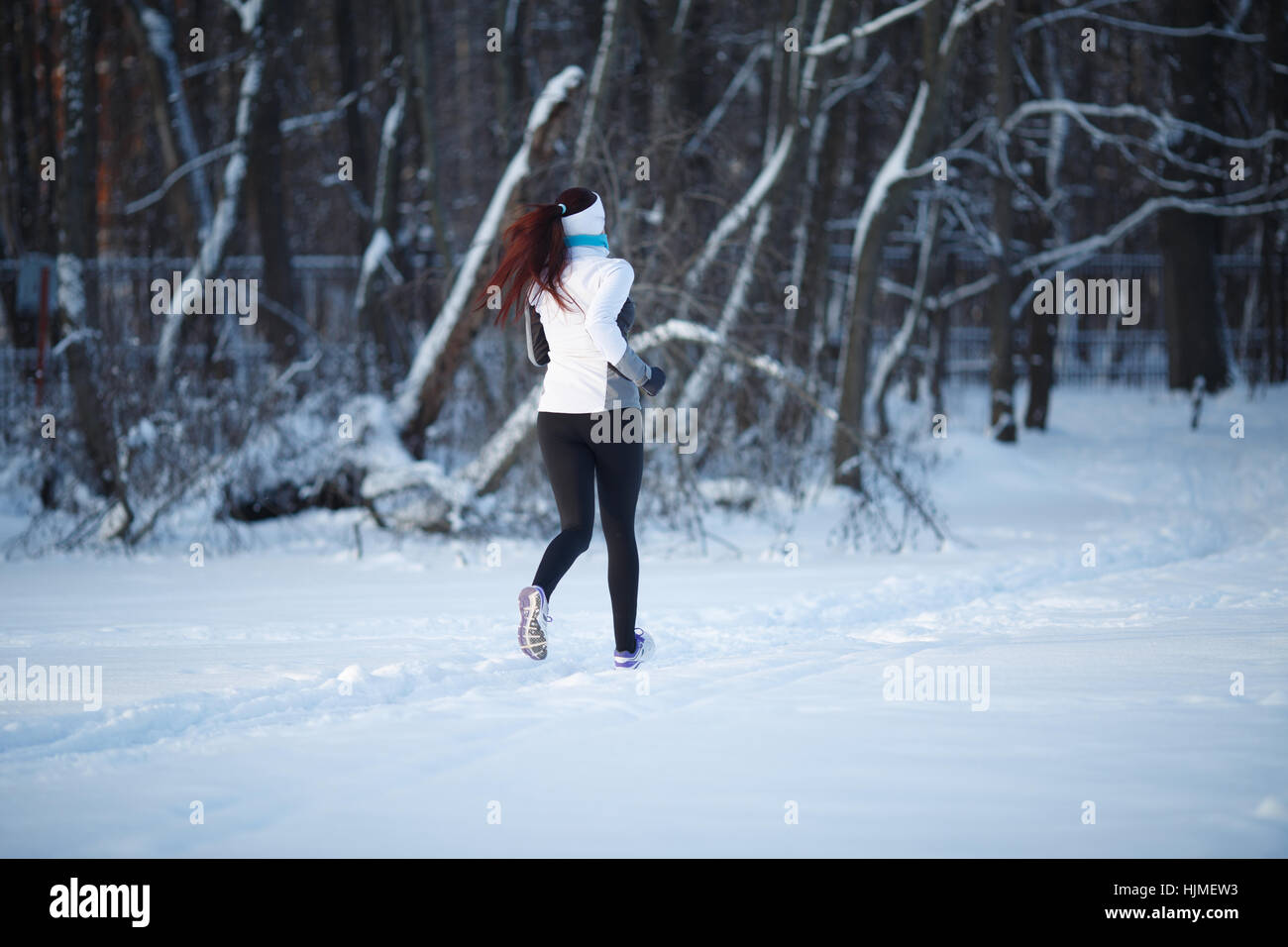 Young girl running among trees Stock Photo - Alamy