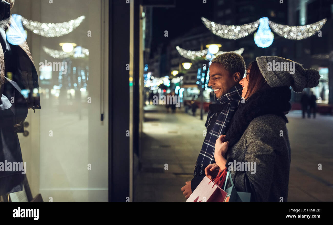 Young couple looking in shop window Stock Photo - Alamy