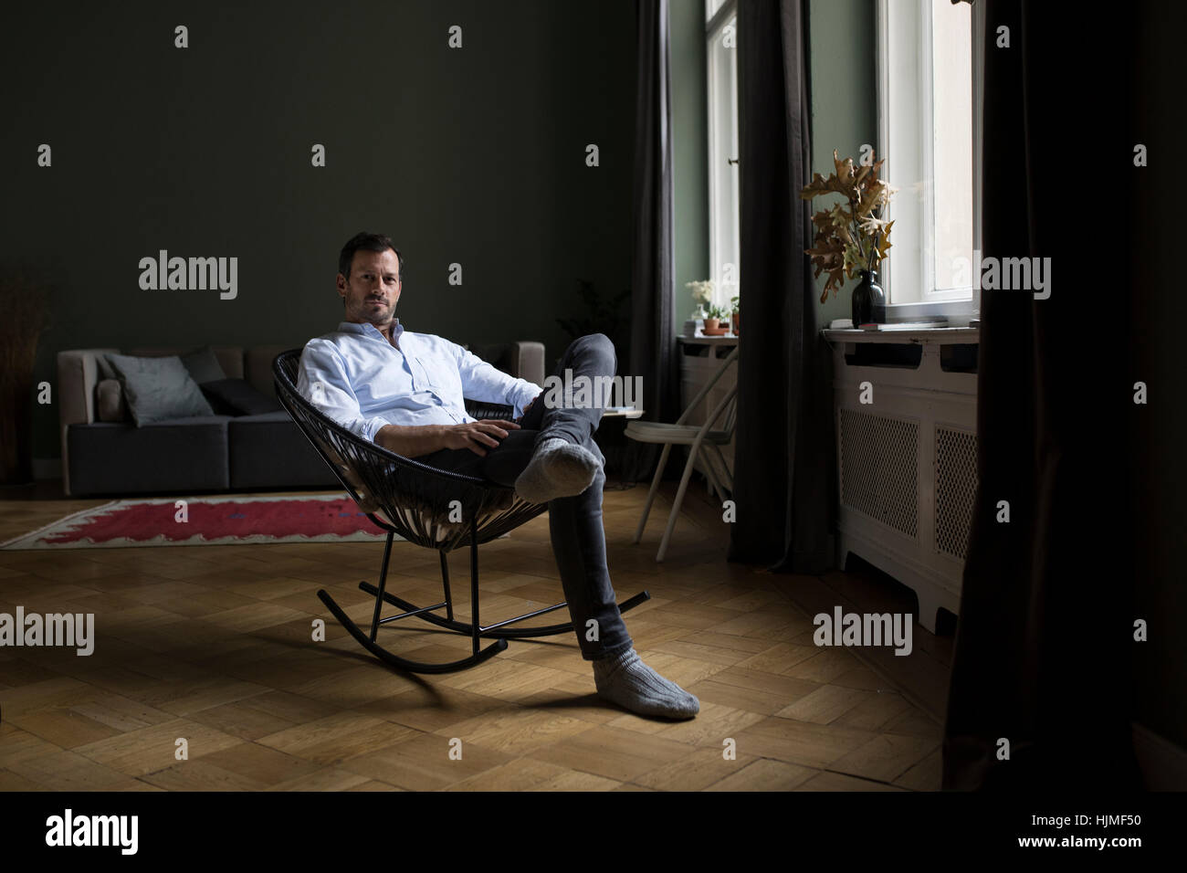 Mature man sitting in rocking hi-res stock photography and images - Alamy