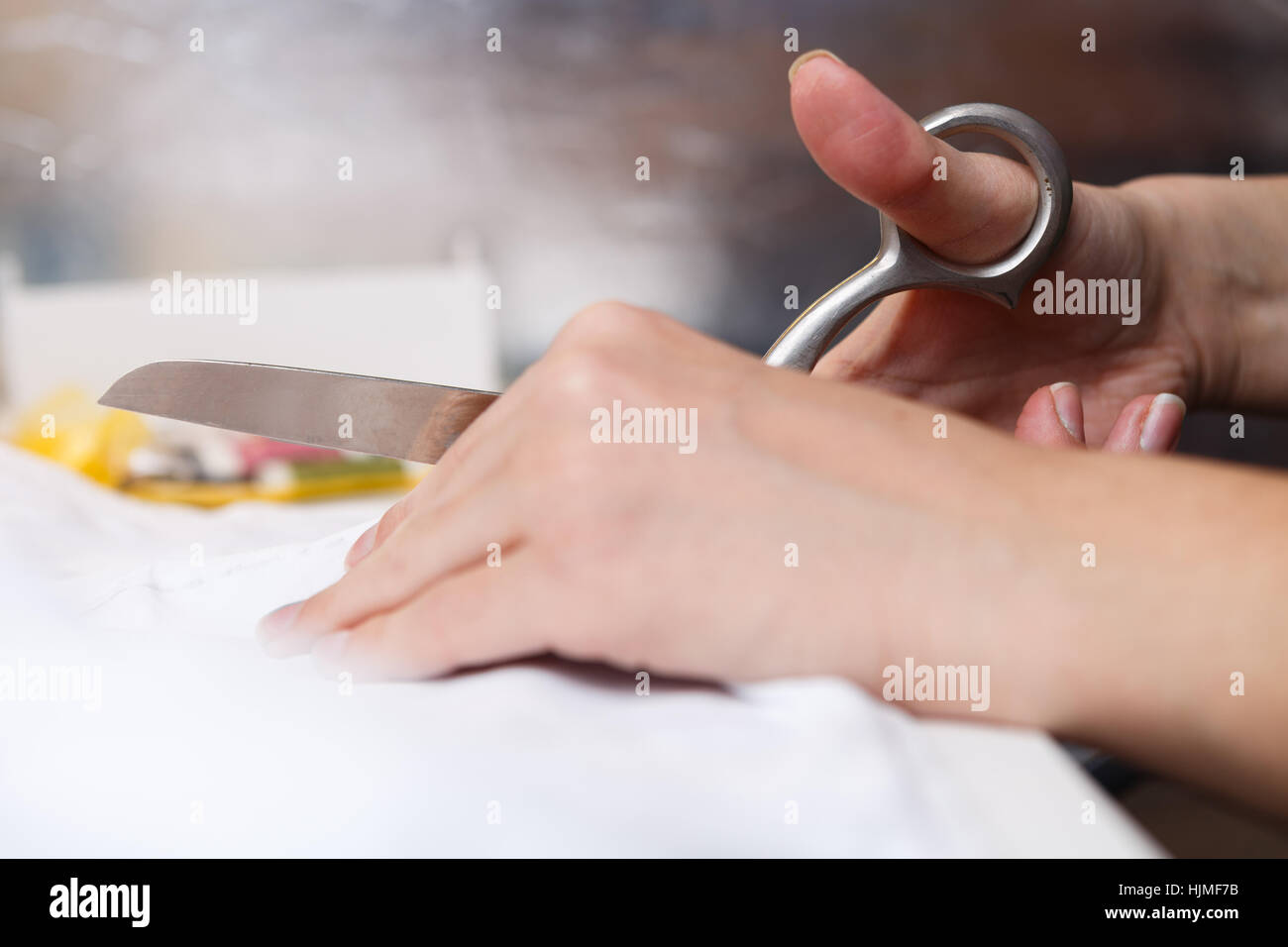 Woman cuts fabric scissors hi-res stock photography and images - Alamy