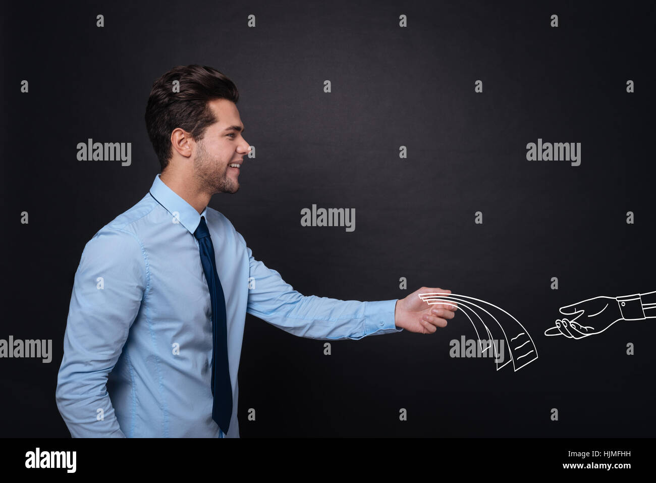 Handsome young delighted man giving documents to someone Stock Photo ...
