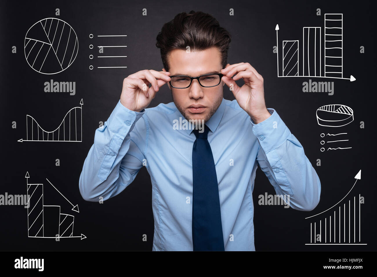 Well dressed handsome young man analysing data Stock Photo - Alamy