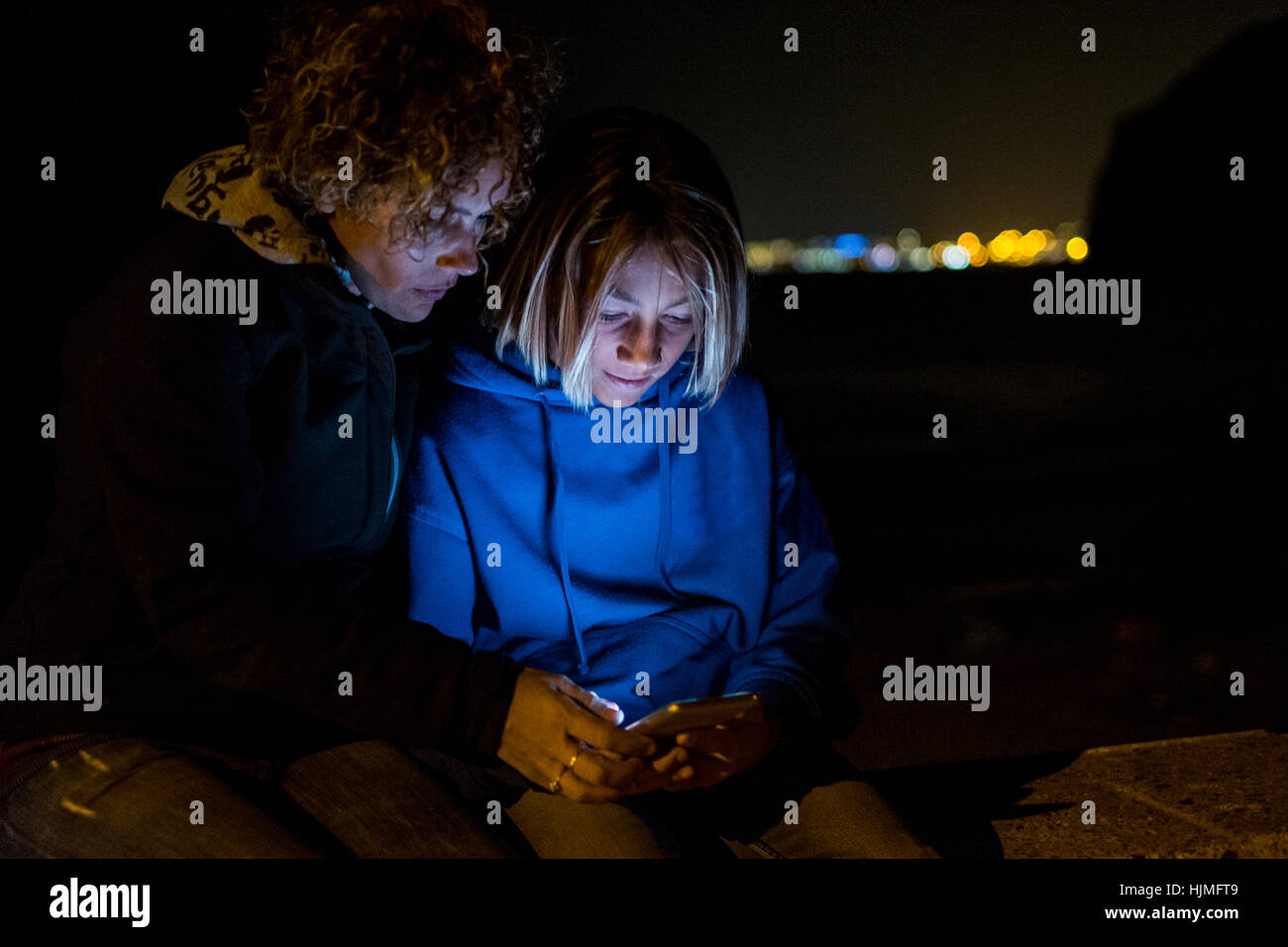 Mother and son using cell phone at night Stock Photo - Alamy