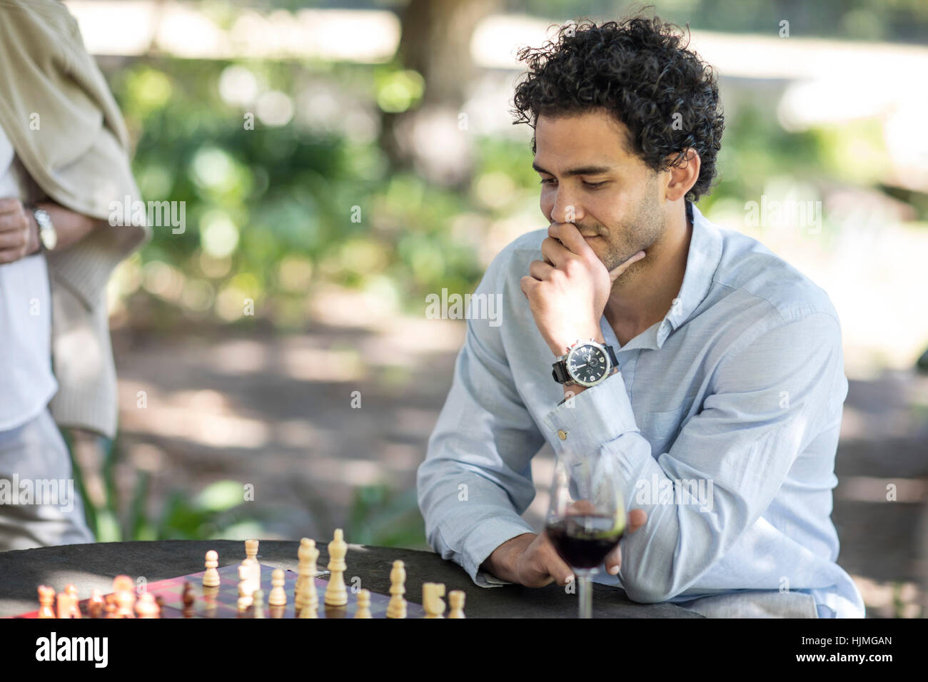 Man playing game of chess thinking Stock Photo - Alamy