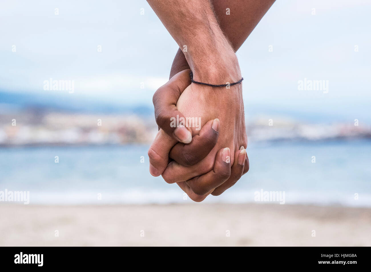 Two interlocked hands hi-res stock photography and images - Alamy