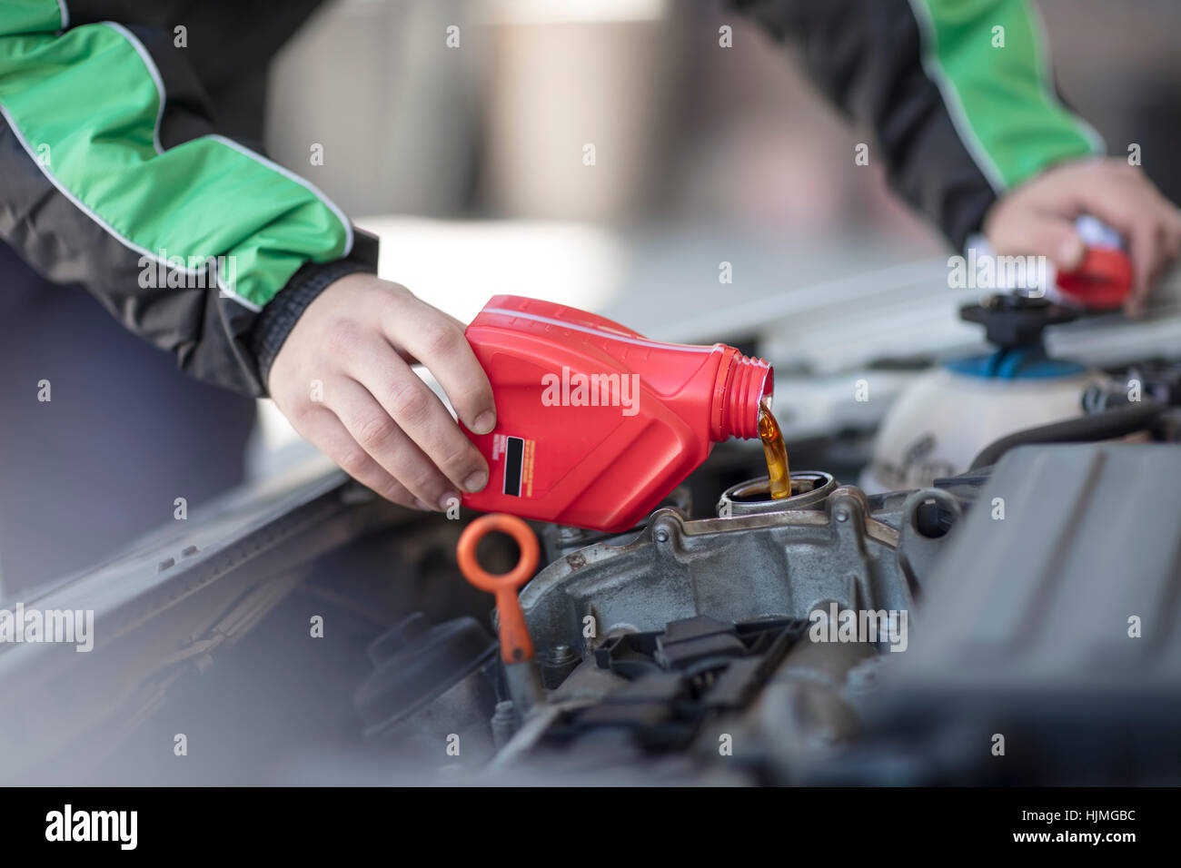 Man filling up car with motor oil Stock Photo - Alamy