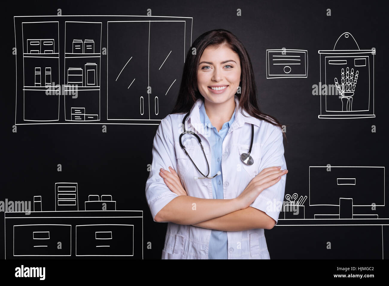 Positive female doctor standing in the hospital Stock Photo - Alamy