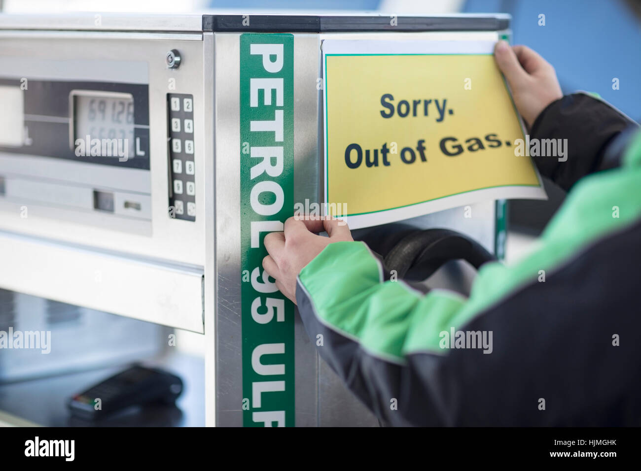 Petrol attendant attaching out of gas sign Stock Photo - Alamy