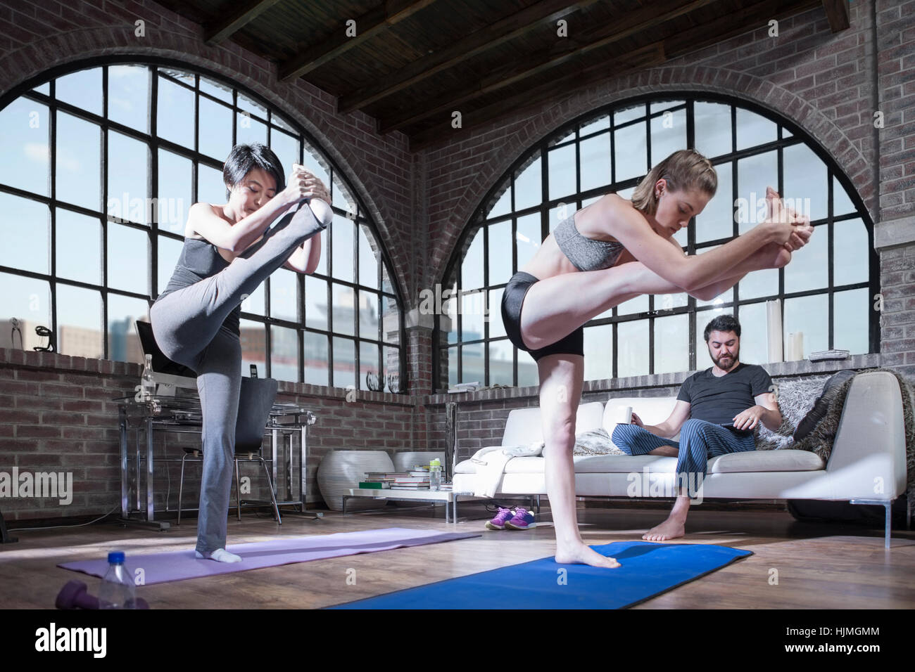 Two women doing yoga exercise in studio Stock Photo - Alamy