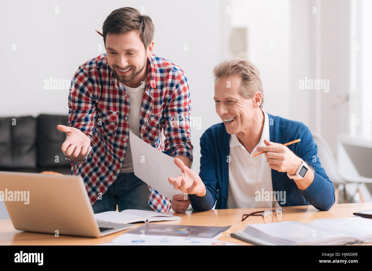 Happy cheerful colleagues enjoying their work Stock Photo - Alamy