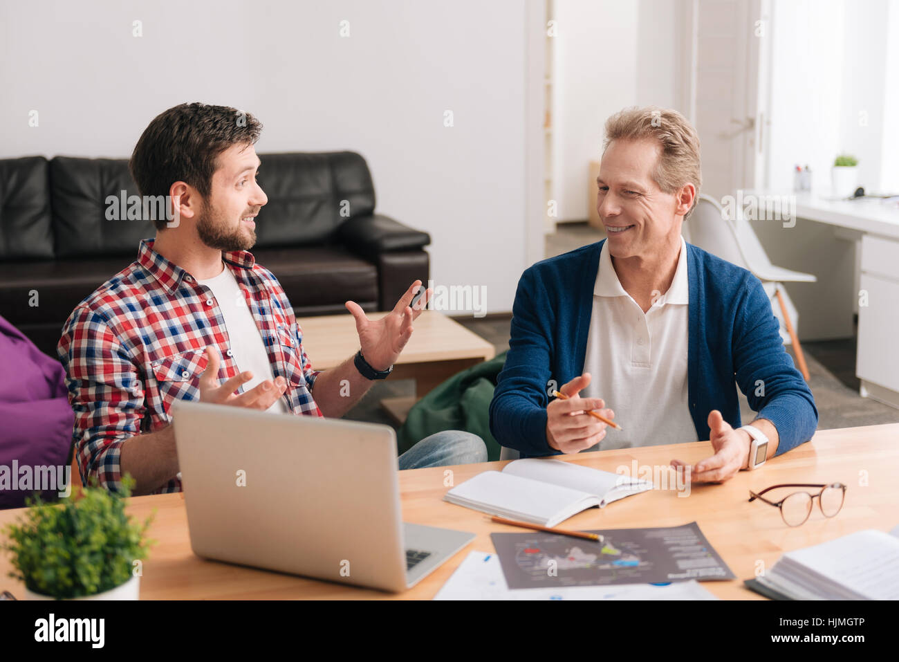 Cheerful good looking men having a conversation Stock Photo - Alamy