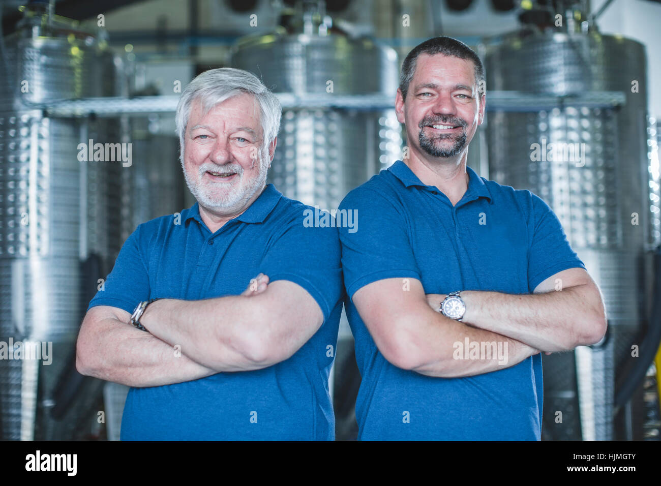 Master distiller standing in distillery with arms crossed Stock Photo ...