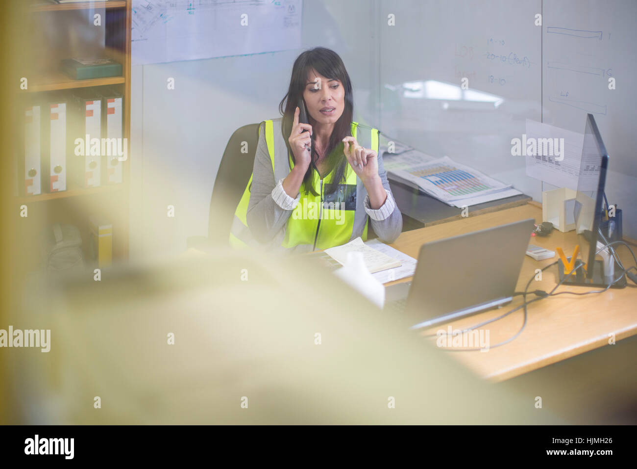 Female construction engineer making a call in site office Stock Photo ...