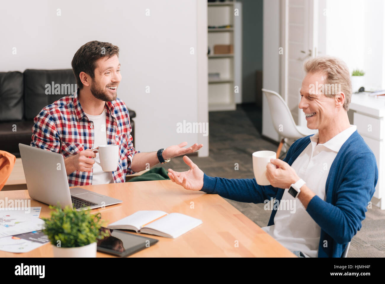 Cheerful happy men enjoying tea Stock Photo - Alamy
