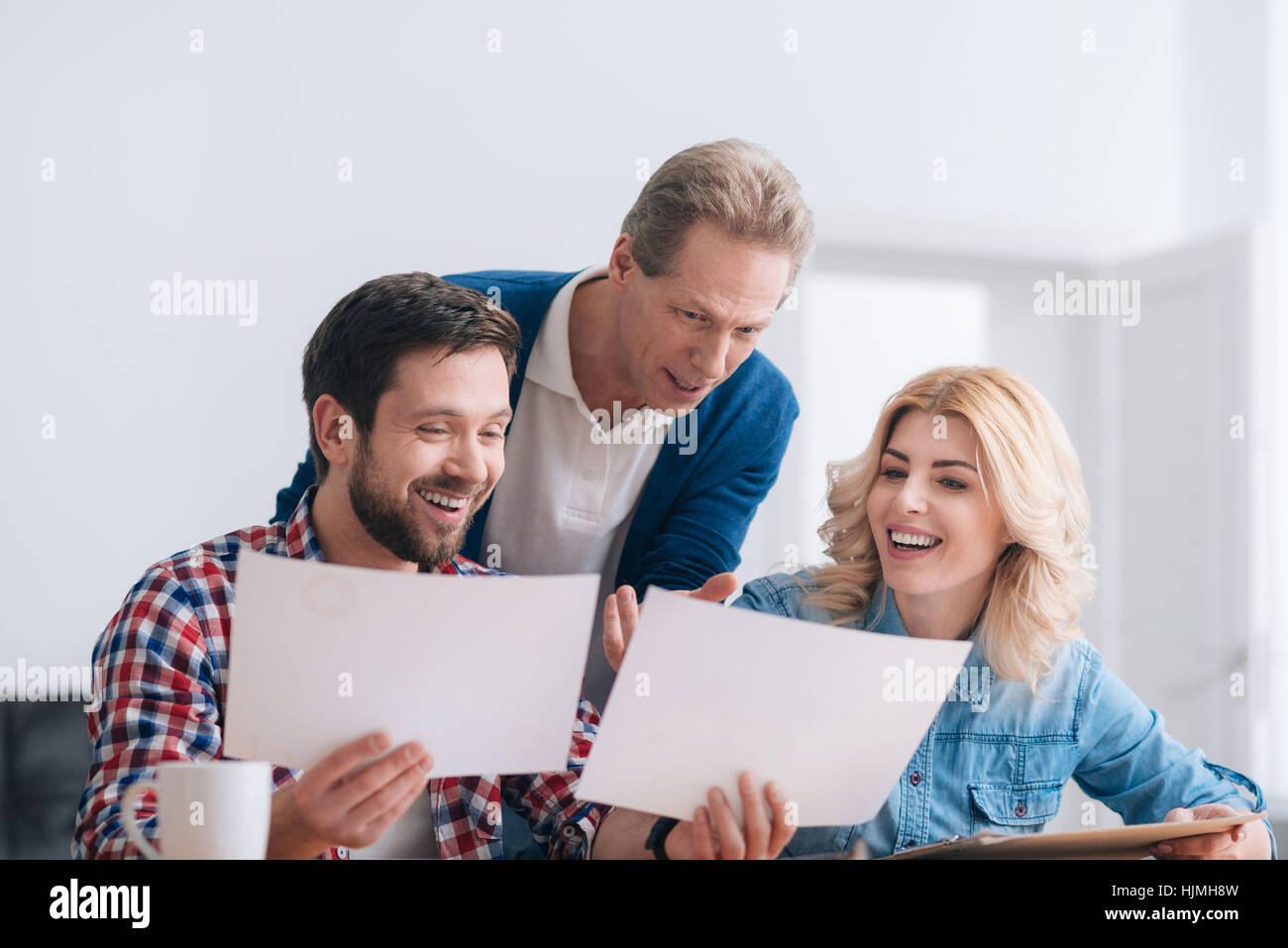 Handsome nice man pointing at the sheet of paper Stock Photo - Alamy