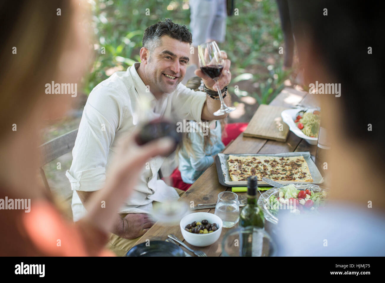 Joyful friends having lunch in hi-res stock photography and images - Alamy