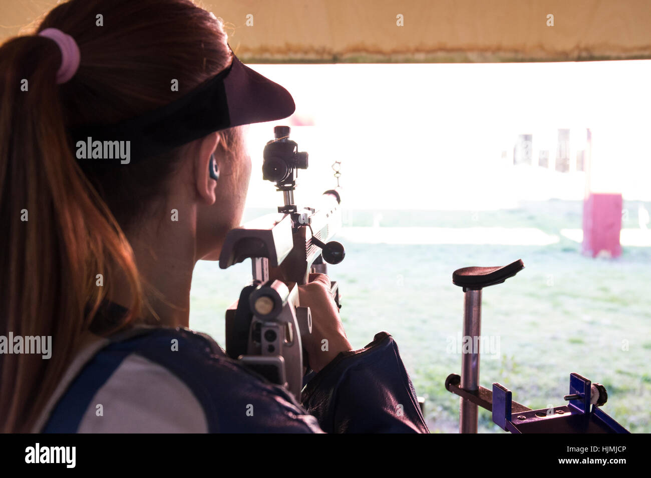 Woman with a sporting rifle in a shooting range Stock Photo - Alamy
