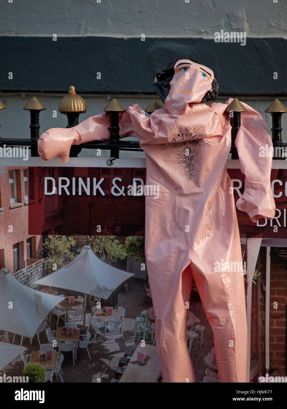 An abandoned, inflatable male figure hangs off railings in central ...