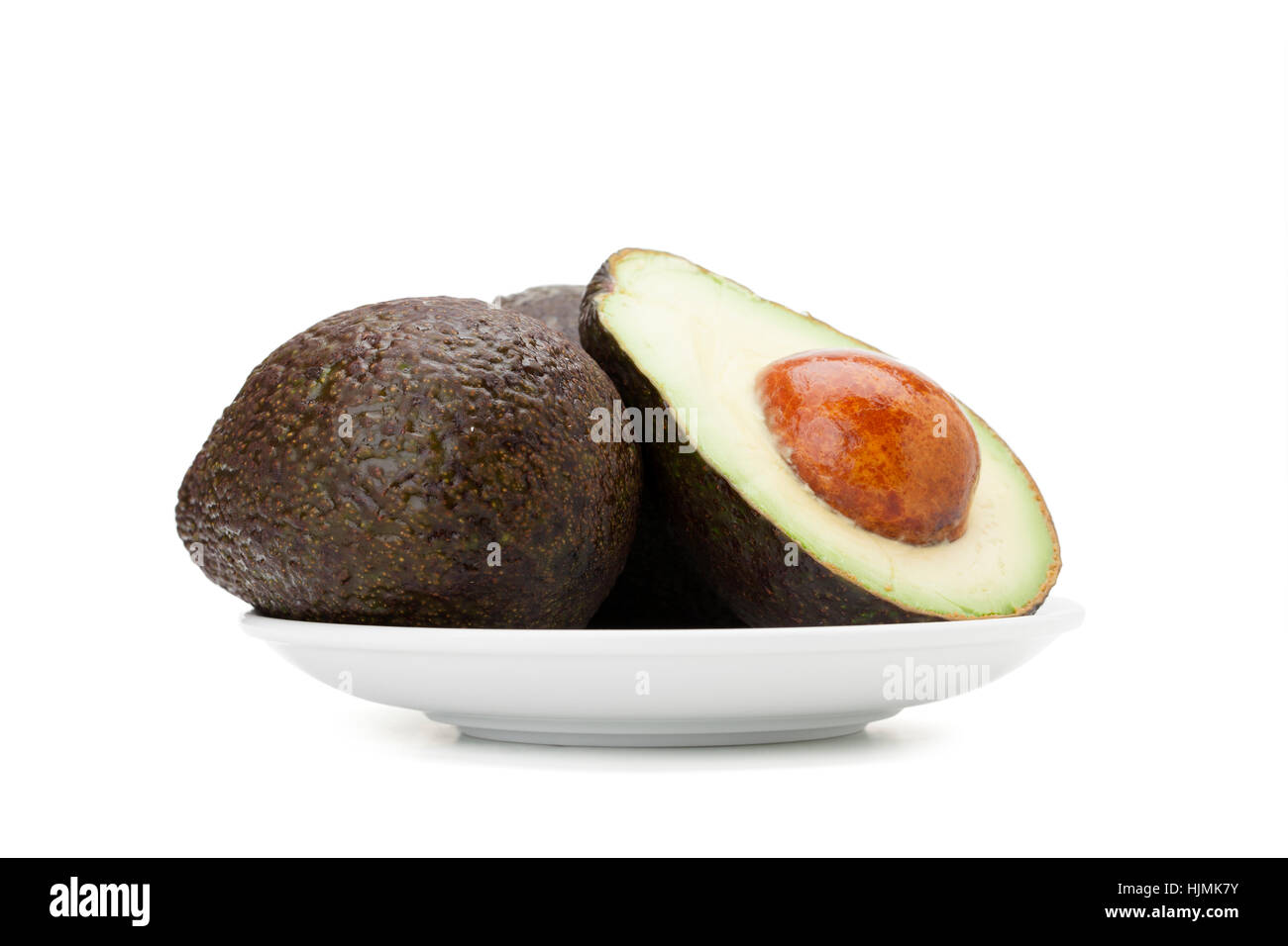 avocado fruit in ceramic plate isolated on white background with ...
